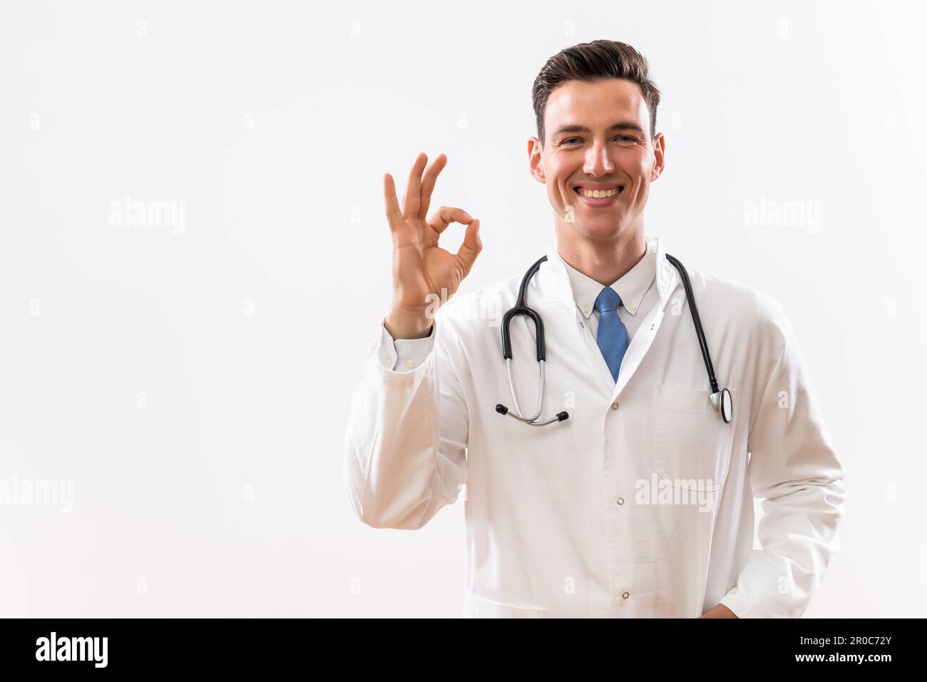 Portrait of young doctor showing ok sign Stock Photo - Alamy