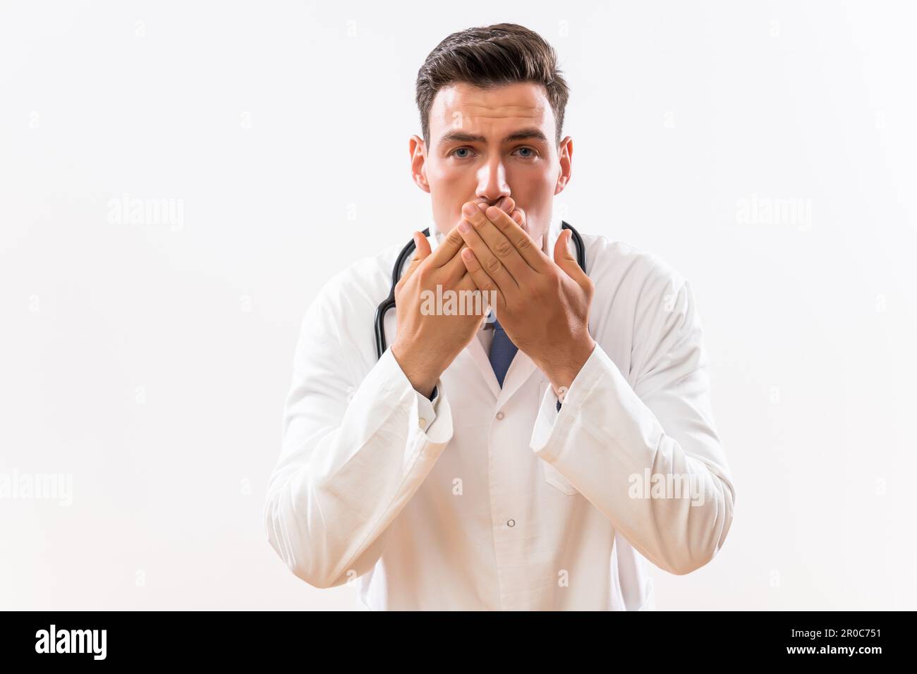 Portrait of shocked doctor with hands covering mouth Stock Photo - Alamy