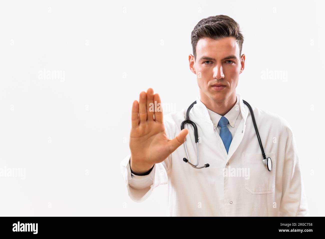 Portrait of young doctor showing stop sign Stock Photo - Alamy