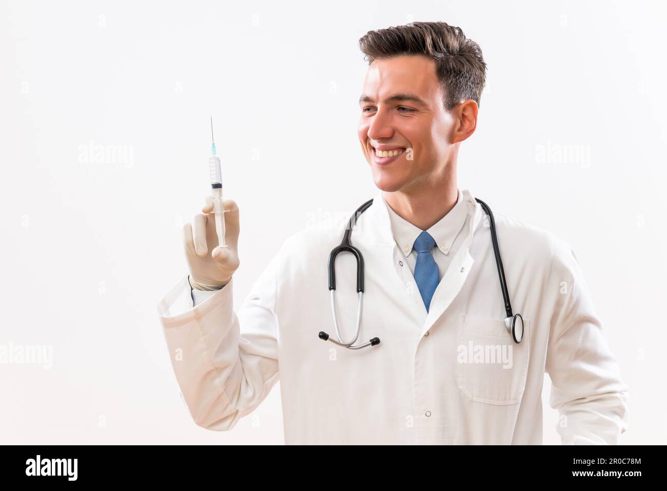 Handsome doctor holding syringe hi-res stock photography and images - Alamy