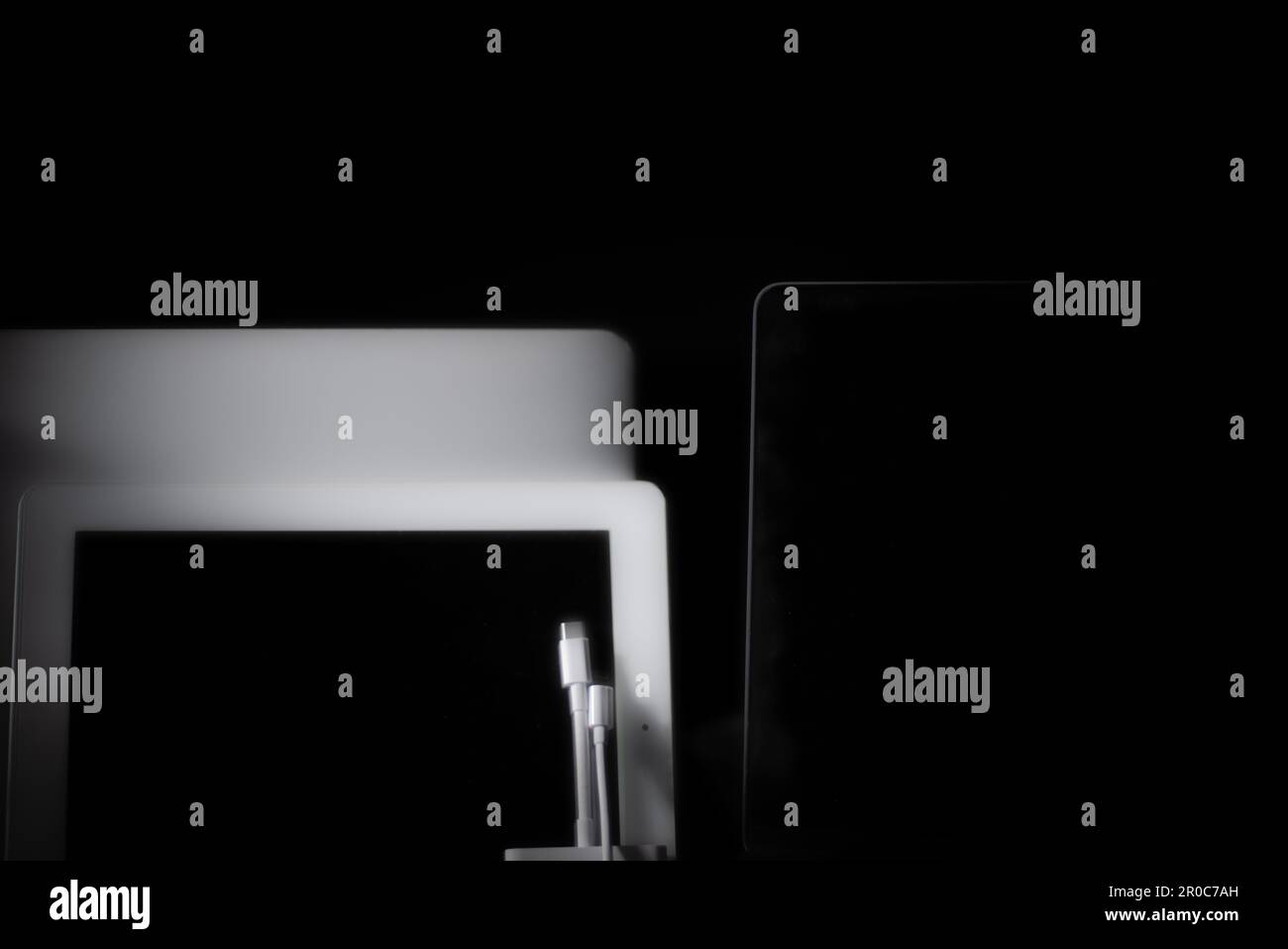 Diffuse Patterns view of laptop,Tablet of workspace in dark background ...