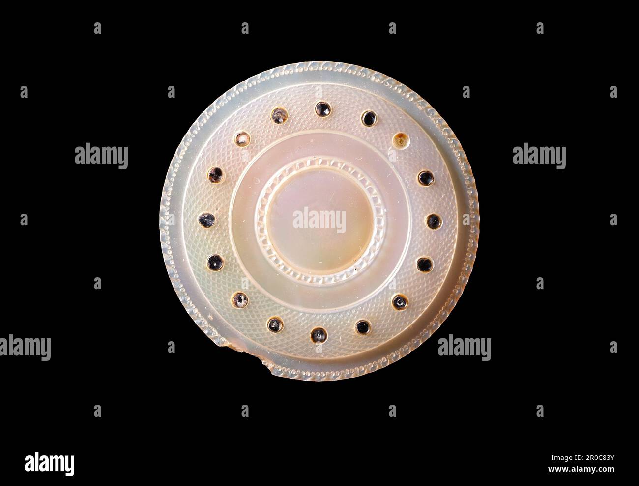 Button. Pearl button, carved and engraved, set with 15 mirror-glass ...