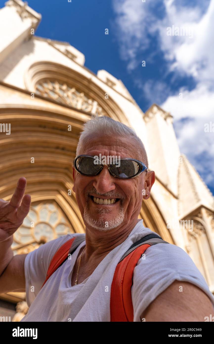 Handsome middle aged man visiting Santa Maria cathedral, Tarragona ...