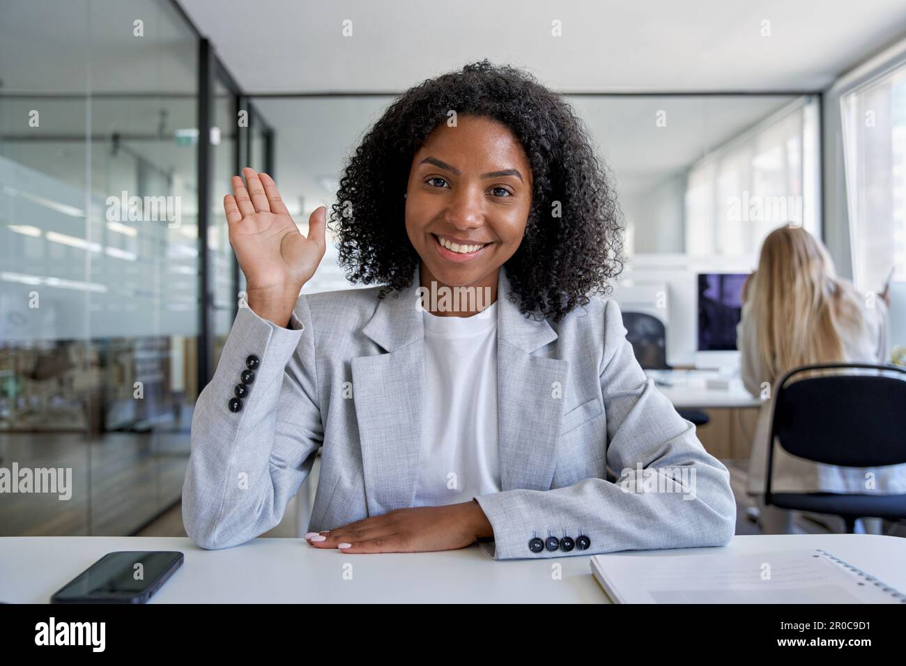 Web cam view of smiling African American businesswoman waving hand at ...