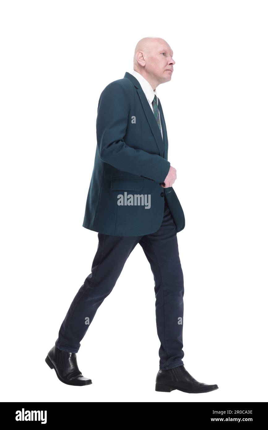 Mature business man striding forward. isolated on a white background ...