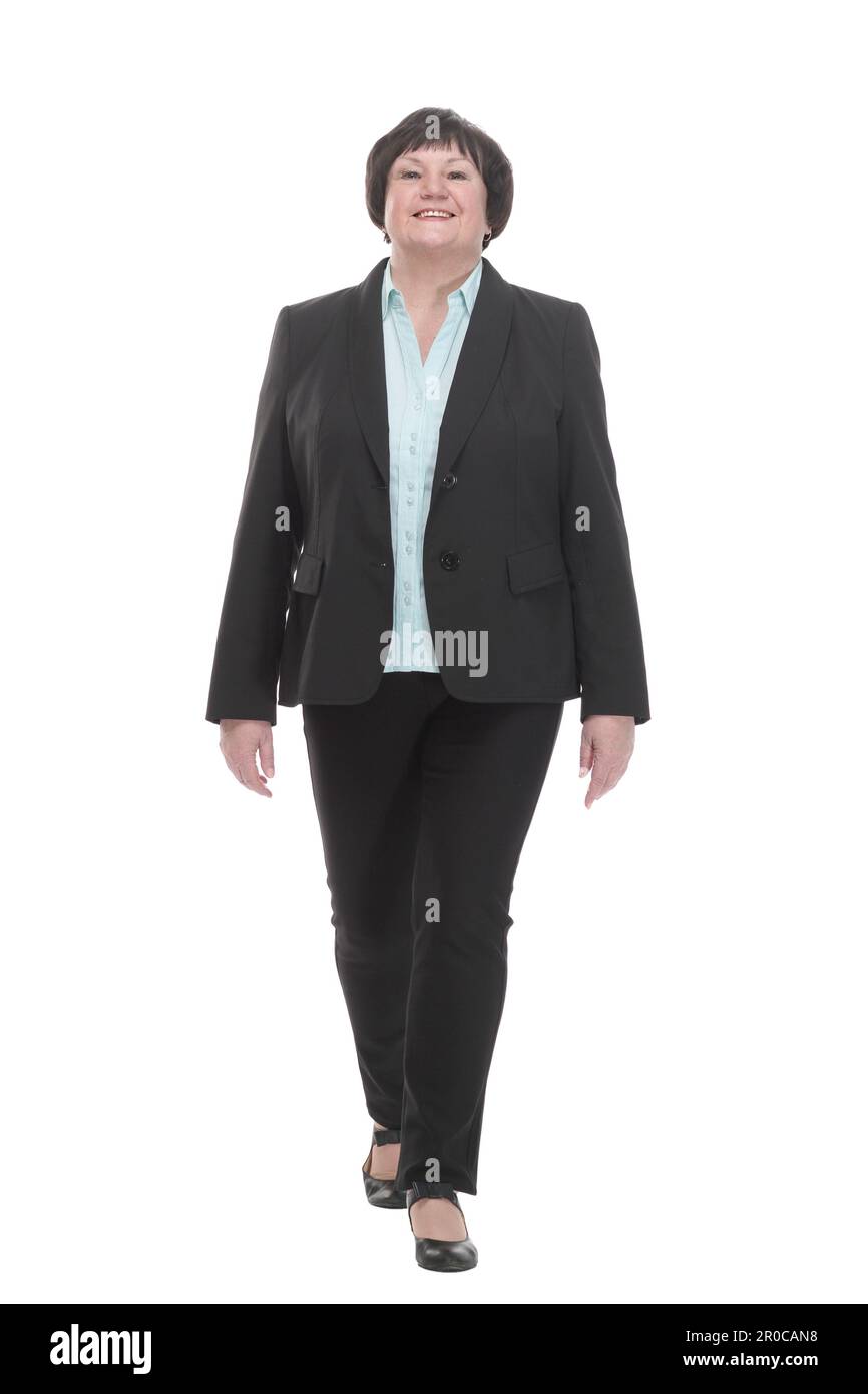 Mature business woman in a pantsuit striding forward Stock Photo - Alamy