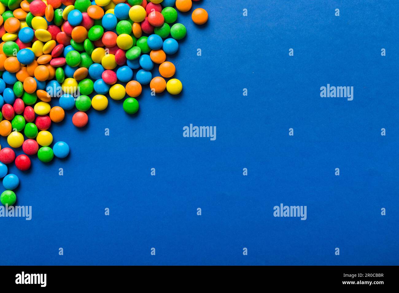 Mixed collection of colorful candy, on colored background. Flat lay ...