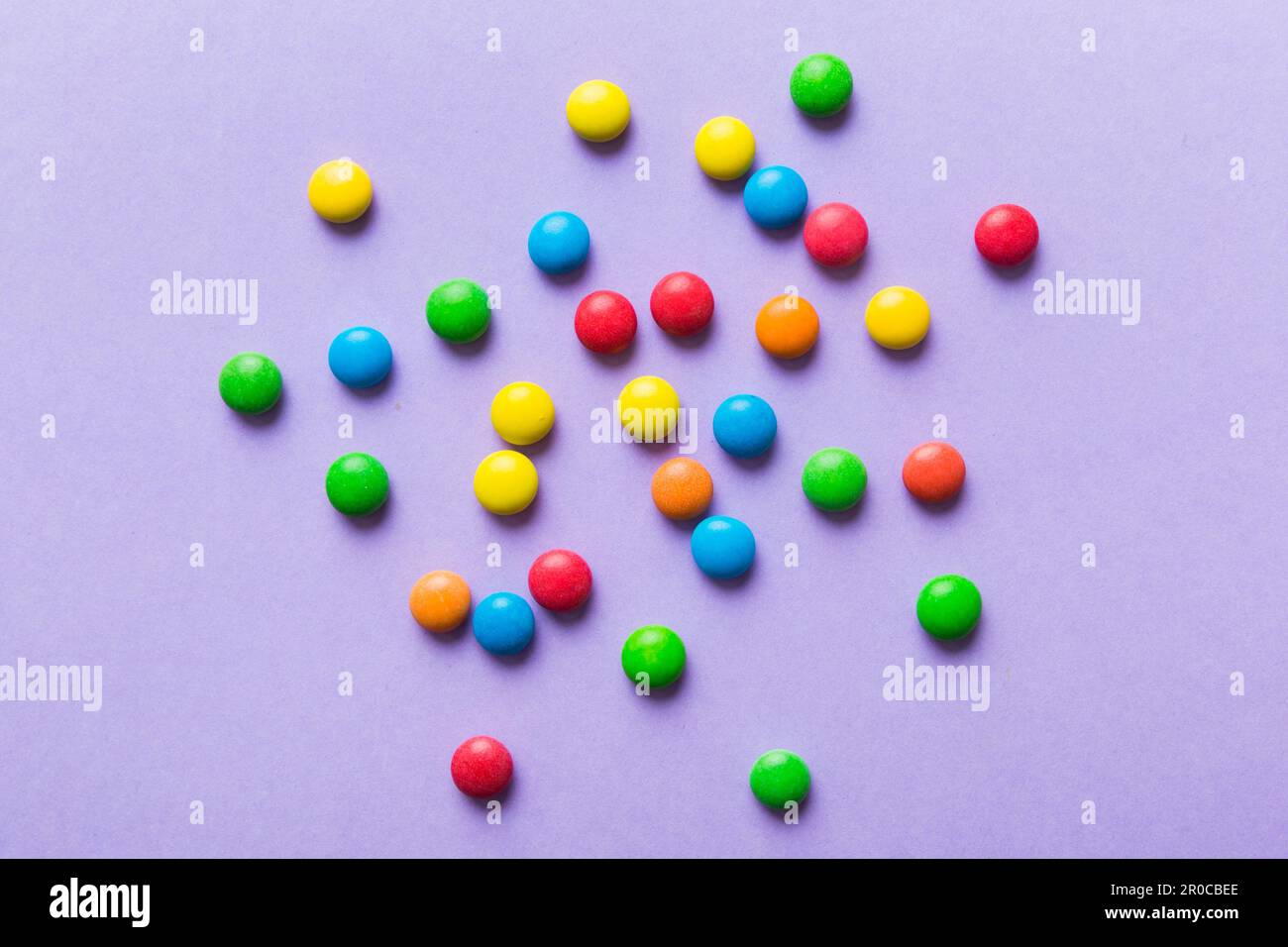 Mixed collection of colorful candy, on colored background. Flat lay ...