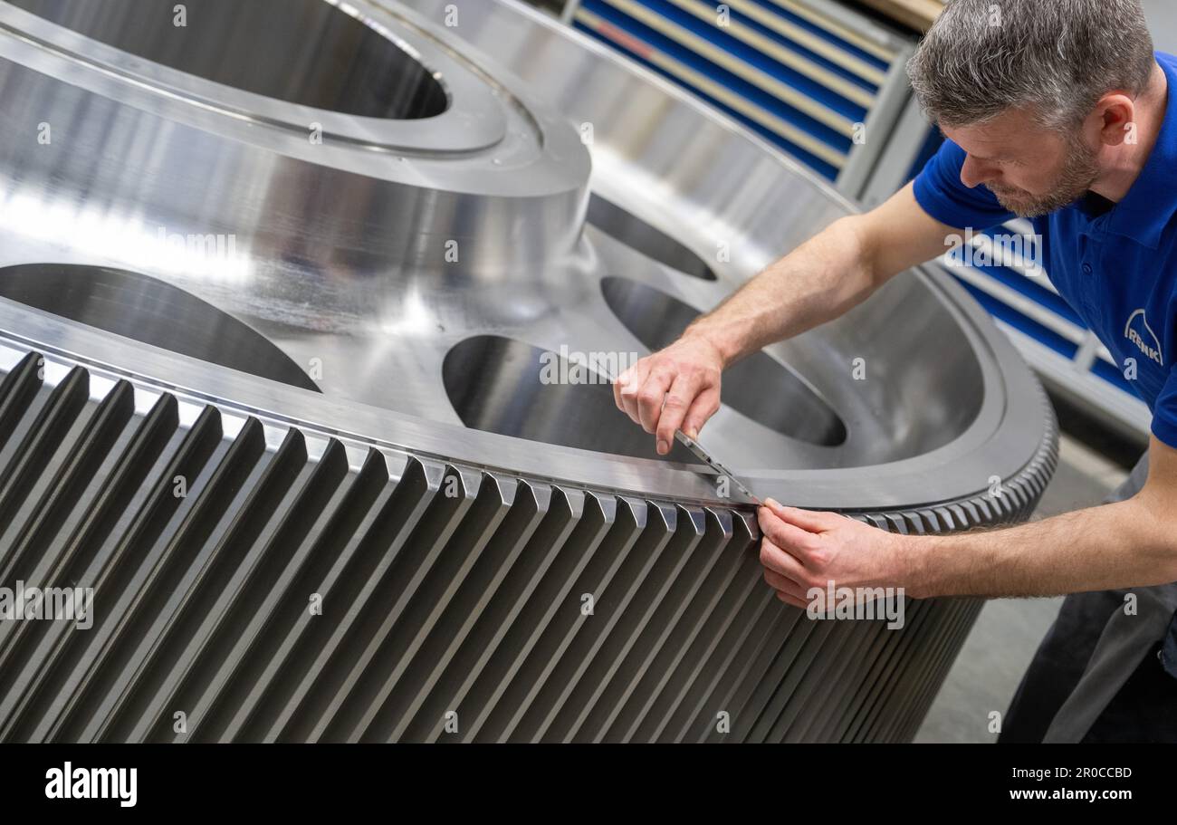 Augsburg, Germany. 08th May, 2023. Robert Wagner inspects a gearwheel ...