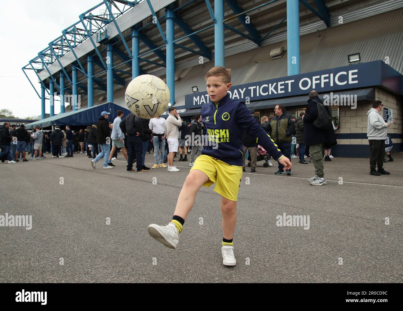A young Millwall fan plays football outside the ground before the Sky ...