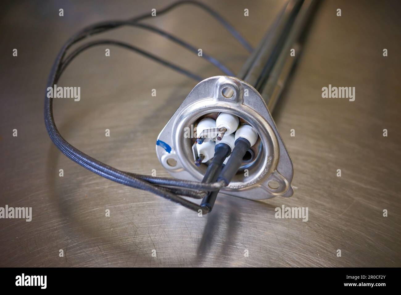 An electric water heater with metal electrodes and heating elements ...