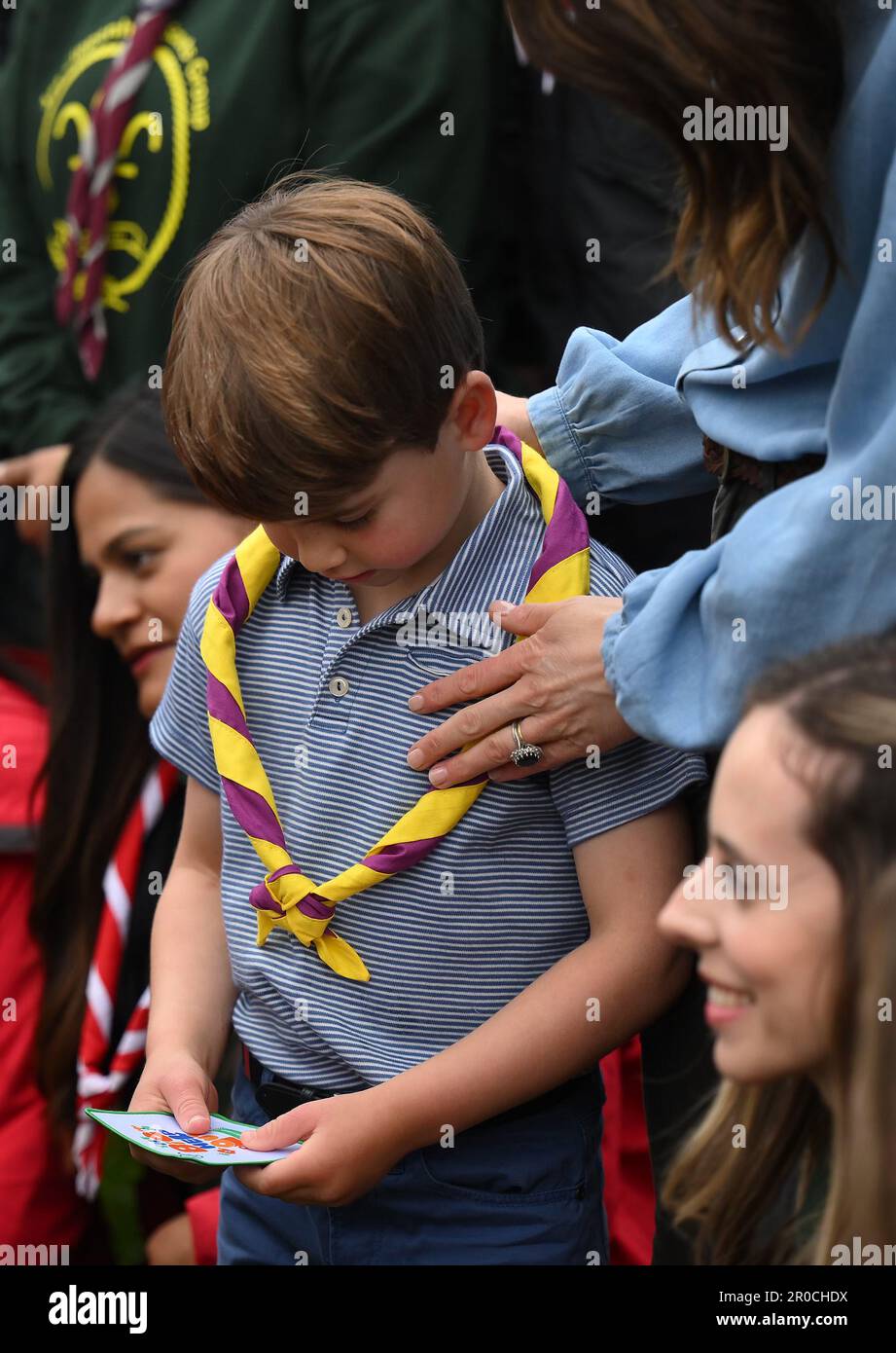 Prince Louis receives a Scouts badge and scarf, also known as a necker ...