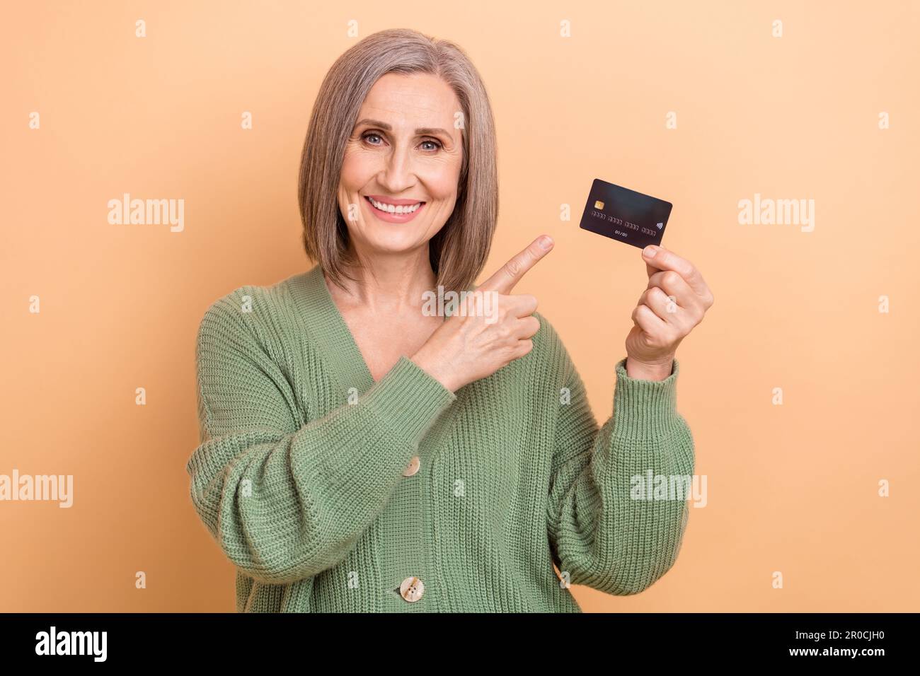 Photo of charming lady indicate finger hand hold plastic debit card ...