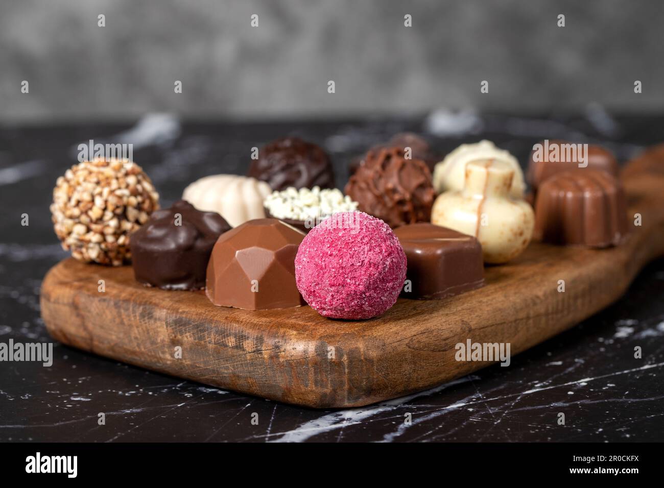 Praline Chocolate. Assorted truffles or praline chocolates on wood ...