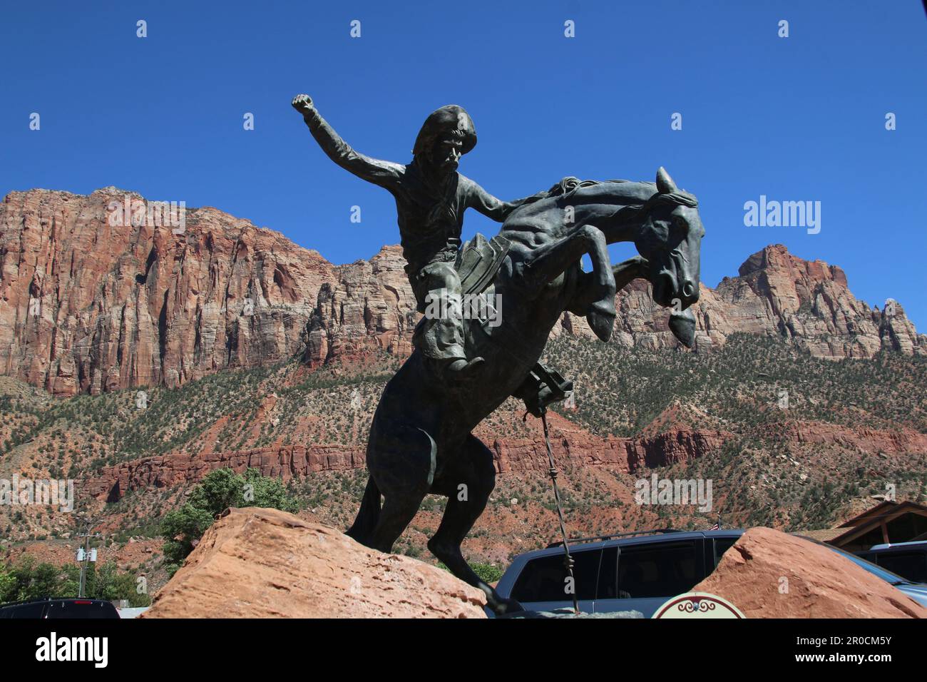 A statue of a cowboy on a rearing horse photographed at Zion National ...