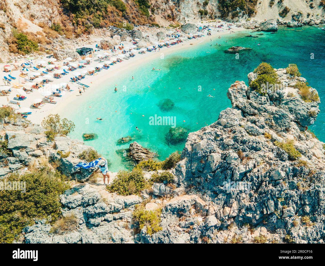 happy woman in blue swimsuit holding greece flag at the top of the ...