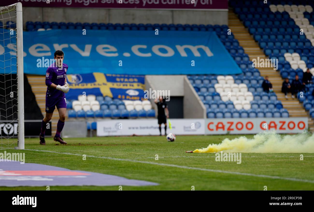 A smoke flare lands on the pitch during the Sky Bet League Two match at ...
