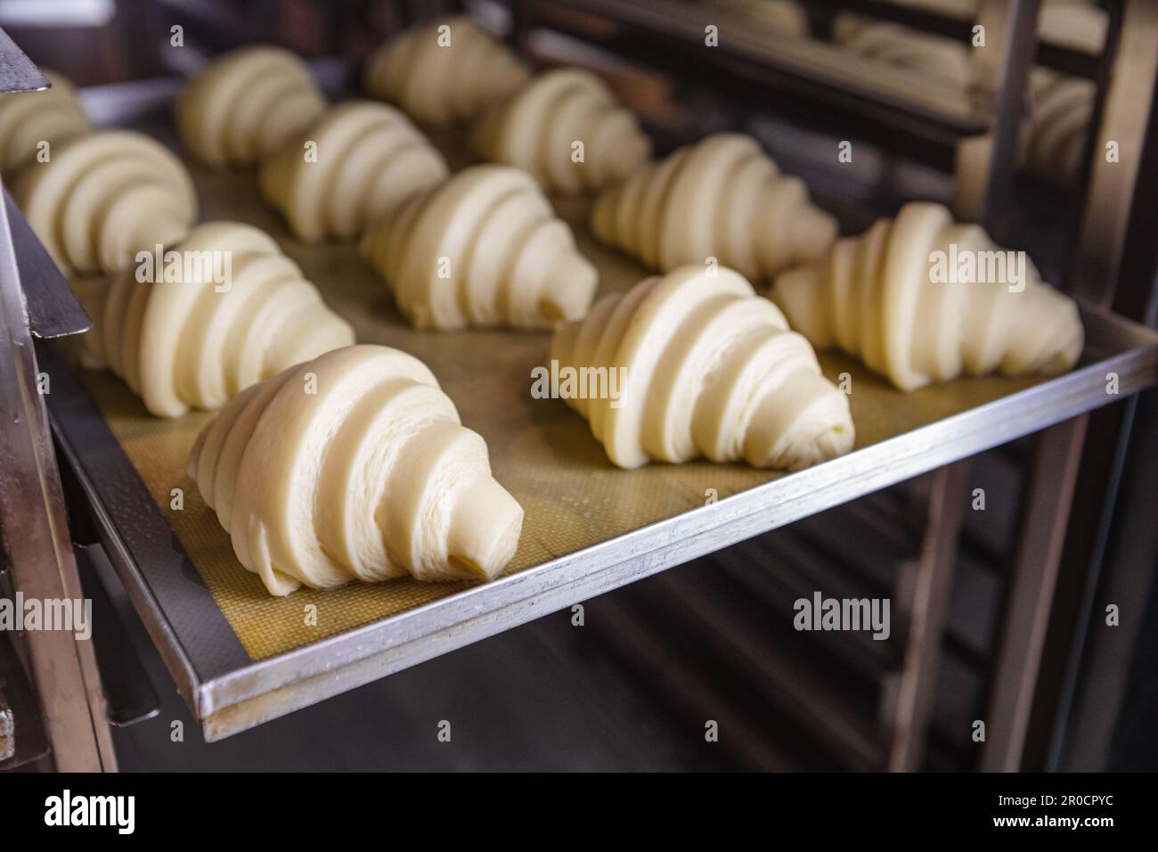 Pre-baked proofed croissant dough Stock Photo - Alamy