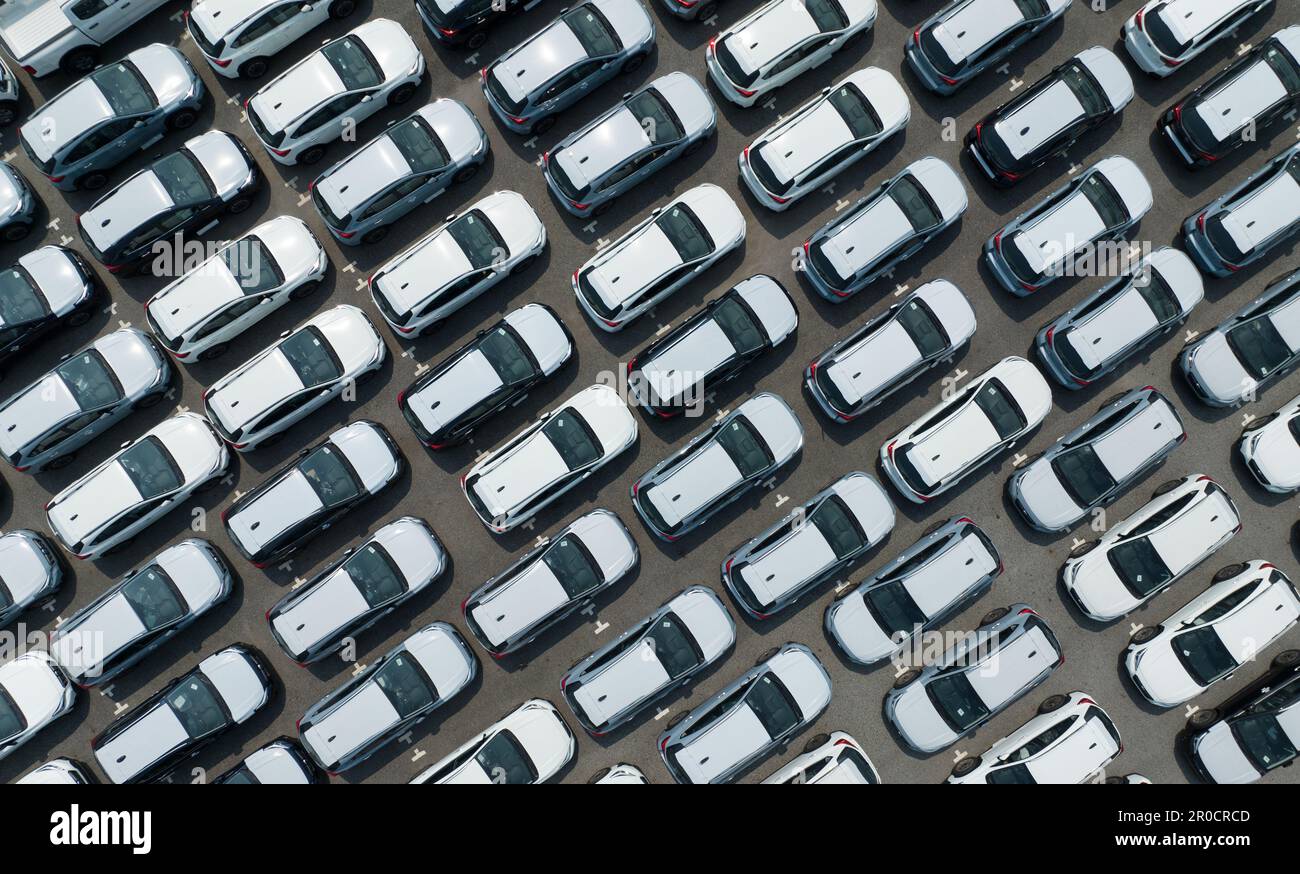 Aerial view of new cars stock at factory parking lot. Above view cars ...