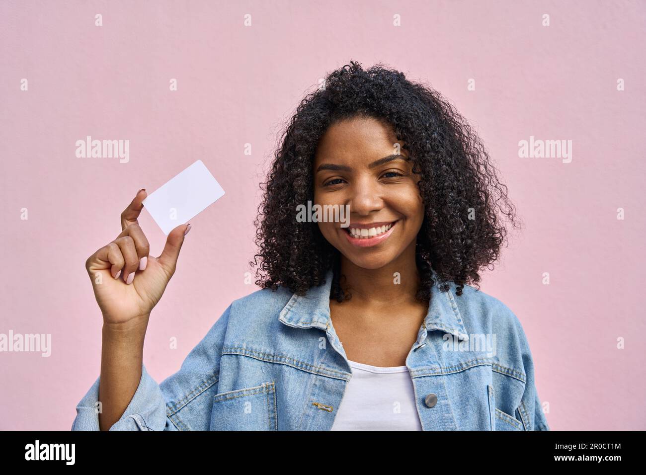 Young African American woman shows a debit credit bank card for online ...