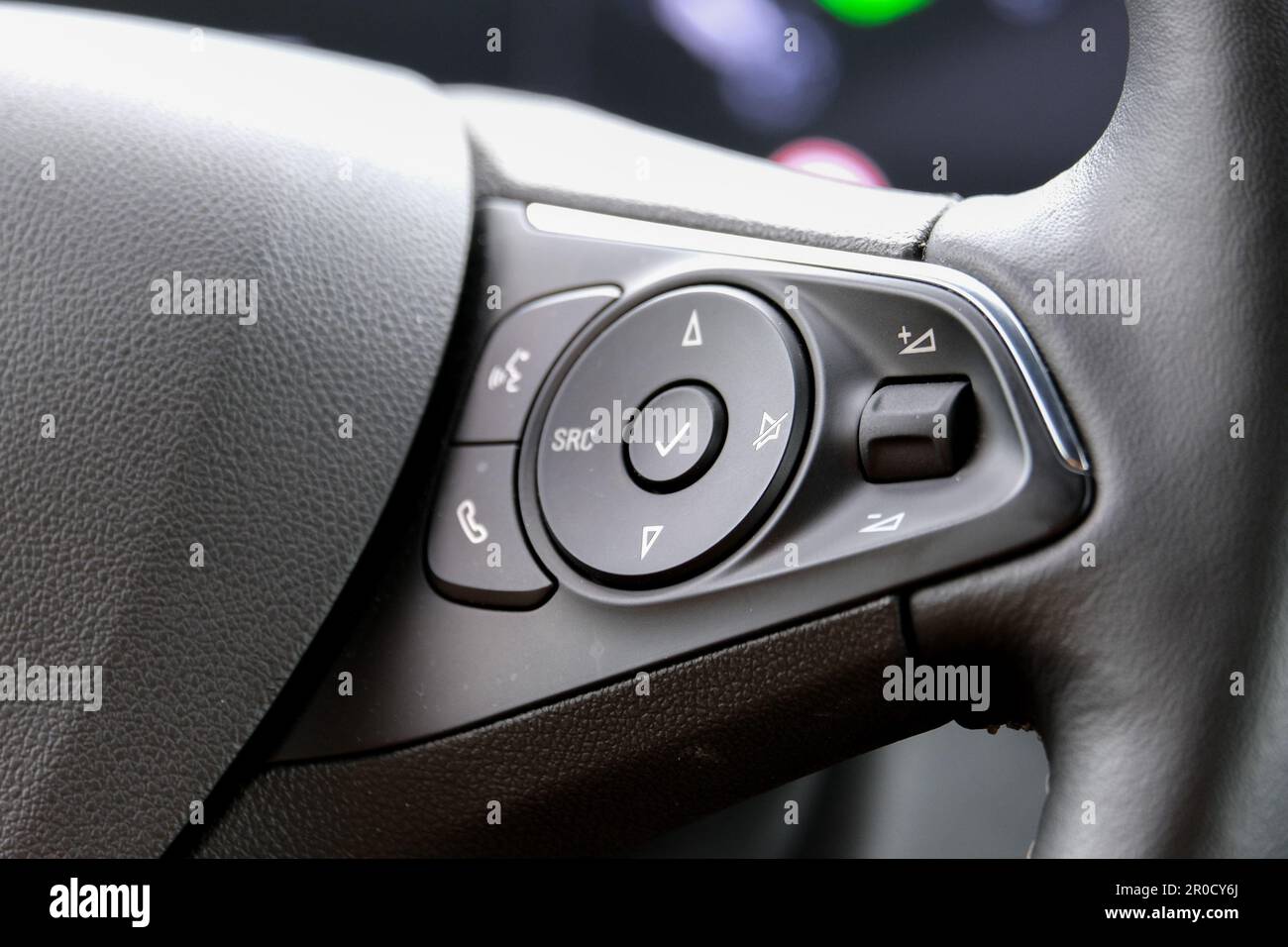 Close up circle buttons on the steering wheel. Selective focus of ...