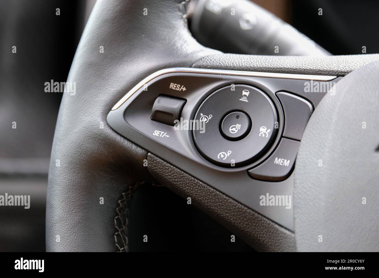 Close up circle buttons on the steering wheel. Selective focus of ...
