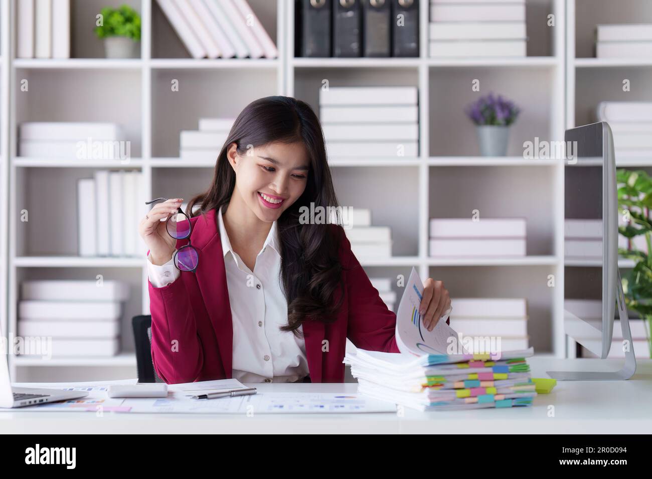 Accountant asian woman working on laptop and do document, tax, exchange ...