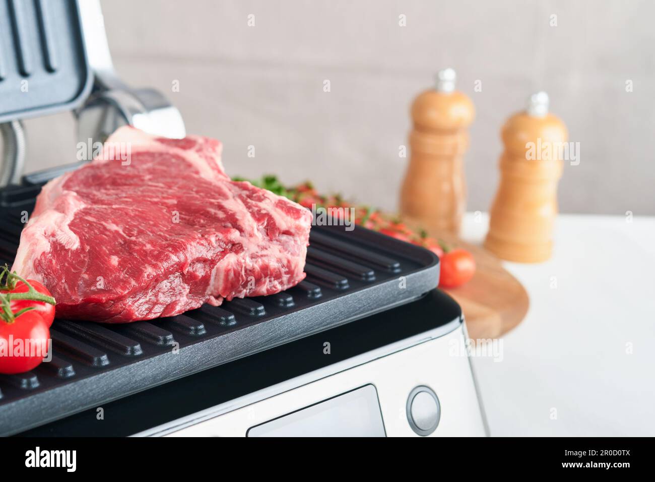 Raw prime steaks on electric grill. Black angus prime meat steaks ...