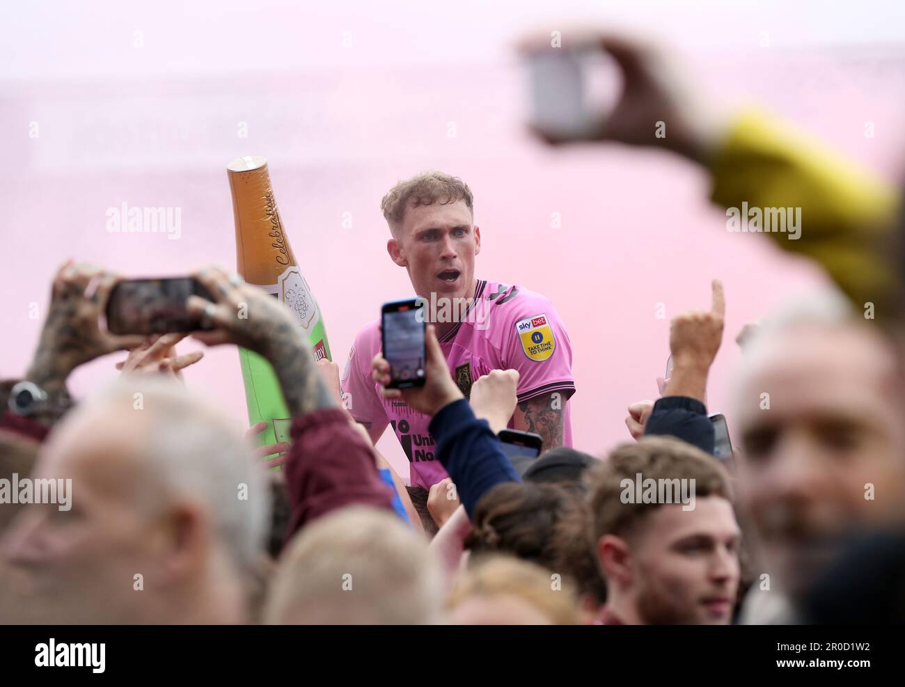 Northampton Town's Mitch Pinnock and the fans celebrate promotion after ...