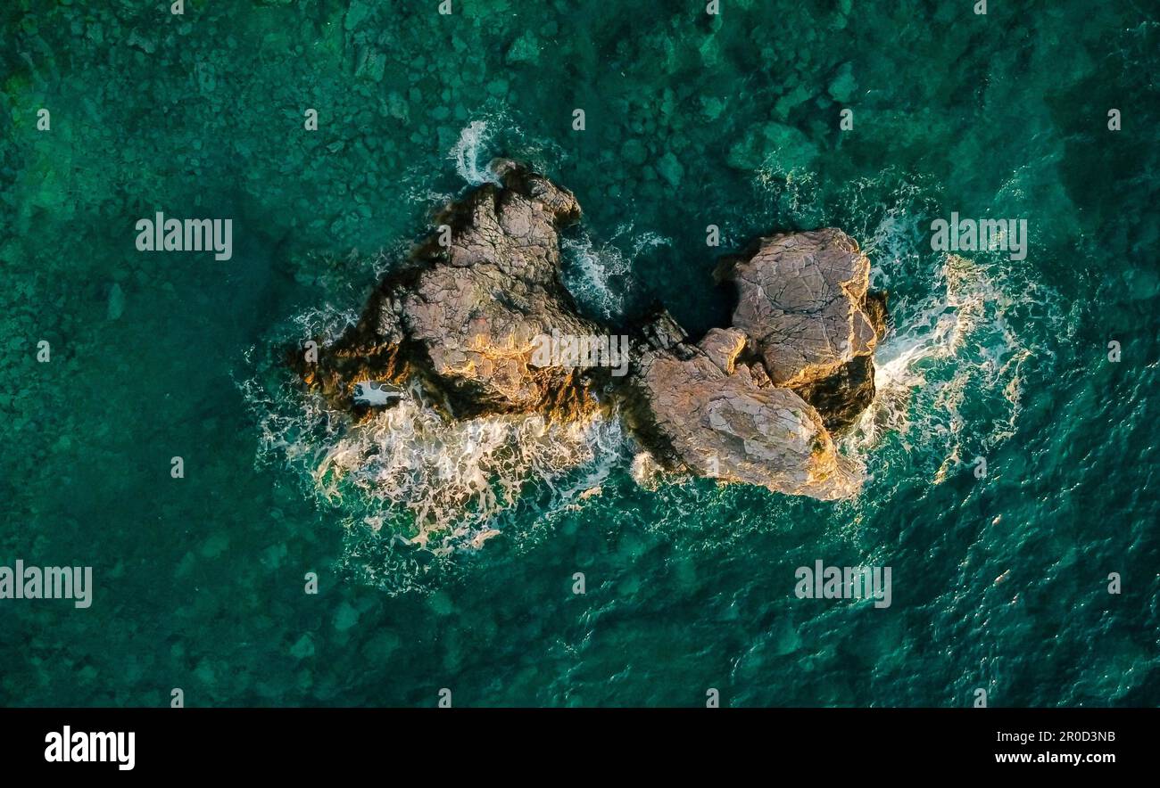 An aerial view of rocks in the turquoise sea Stock Photo - Alamy