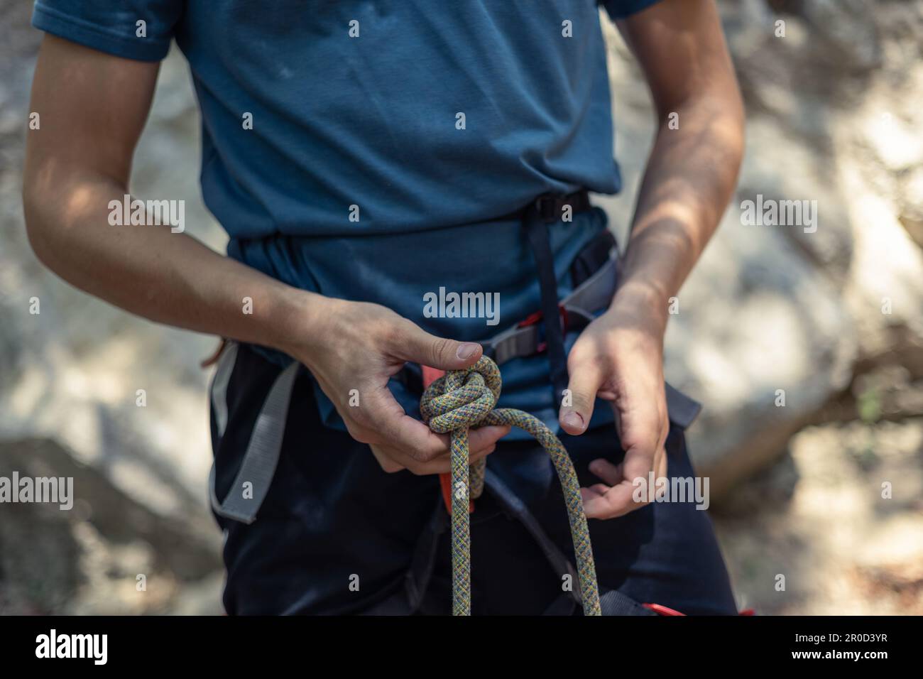 A man adjusting the rope tied around his waist Stock Photo - Alamy