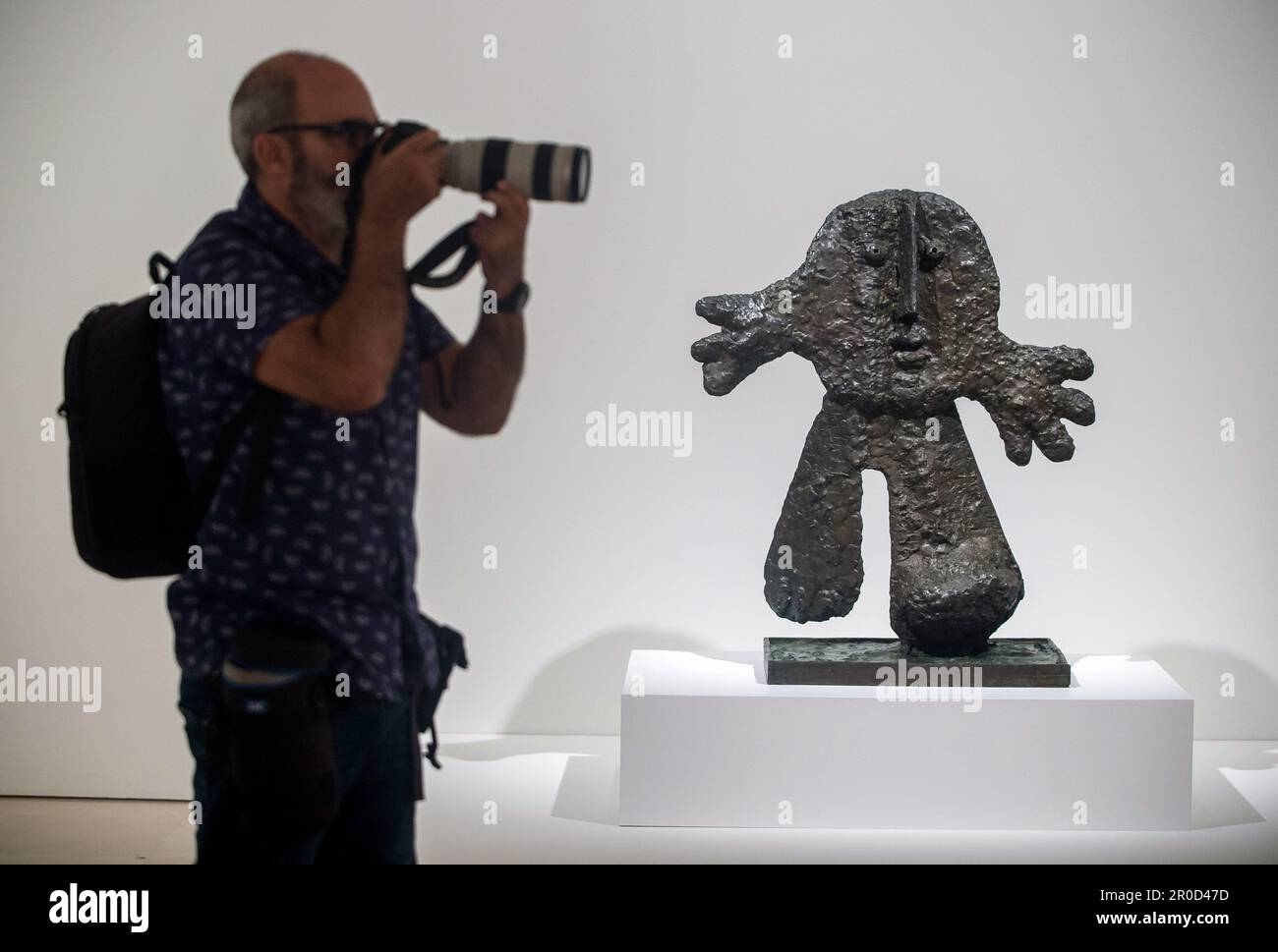 A photographer takes photos of a sculpture during the presentation of ...