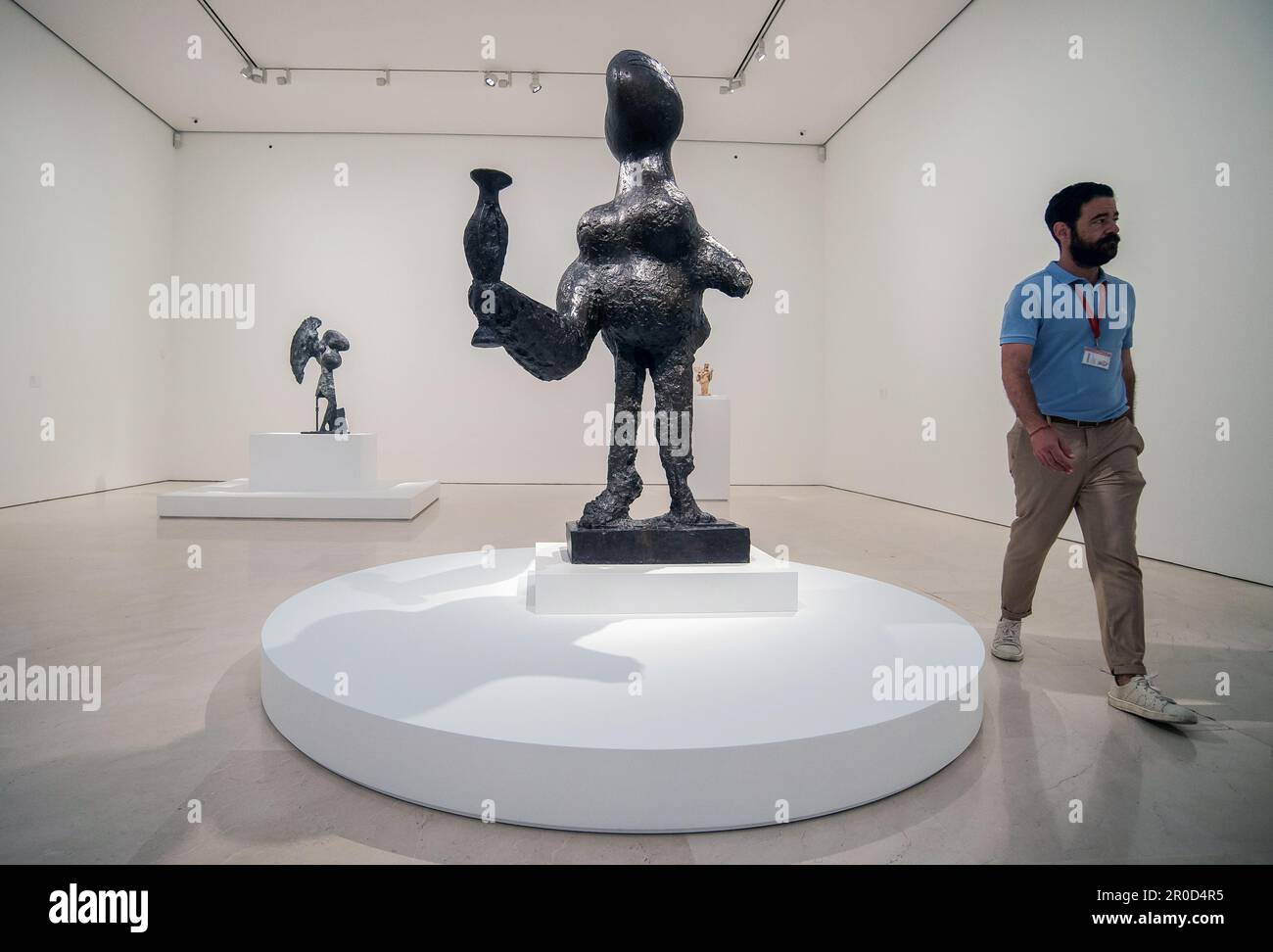 A worker walks past of a sculpture during the presentation of the new ...