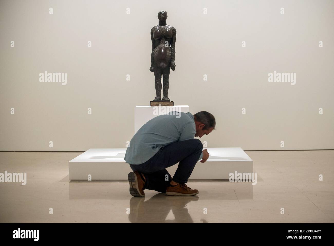 A man takes photos of sculptures during the presentation of the new ...