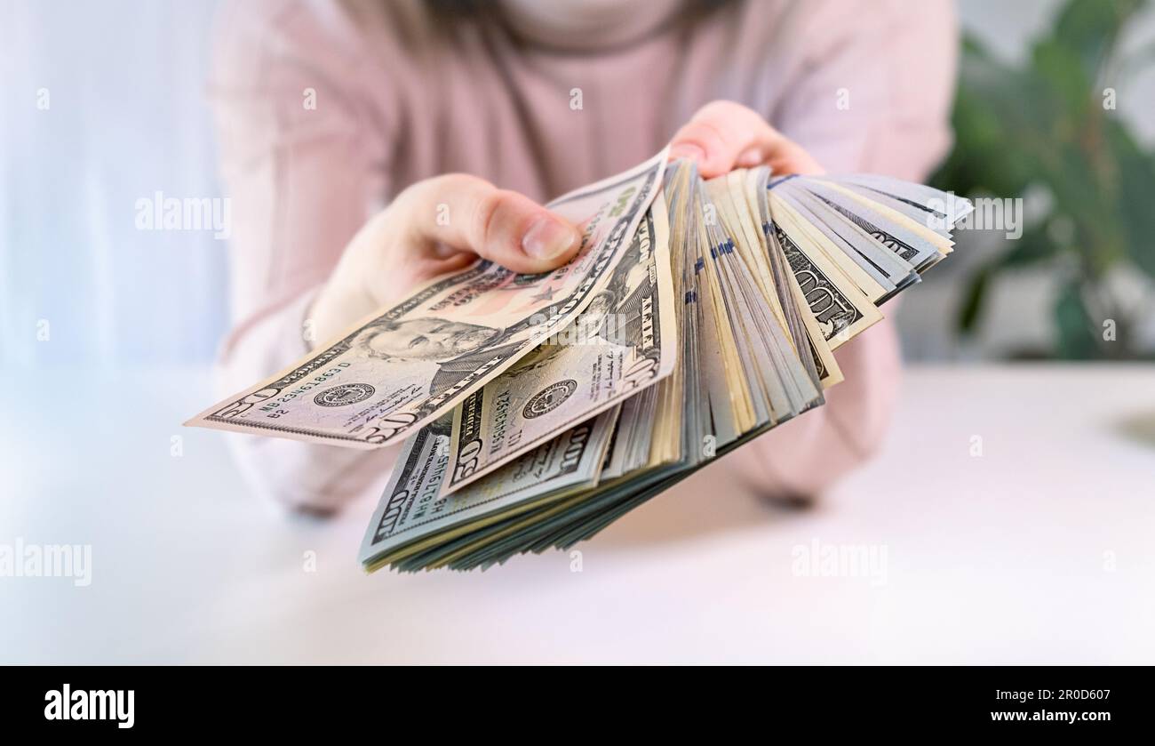 Business Woman Displaying a Spread of Cash over a green vintage ...