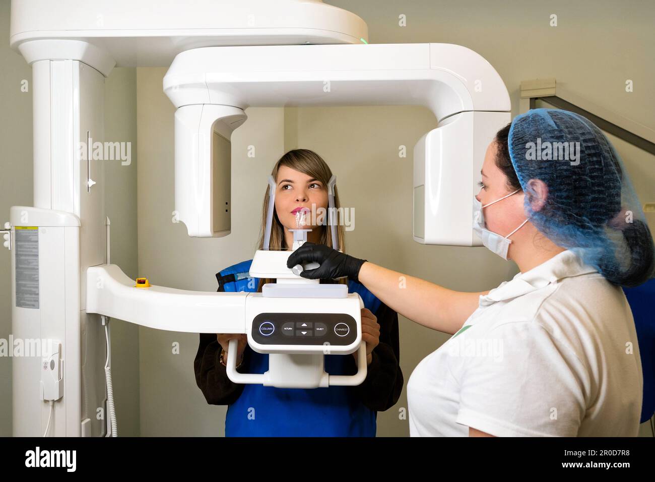 X-ray technician makes CT scan of jaw female patient. Woman making ...