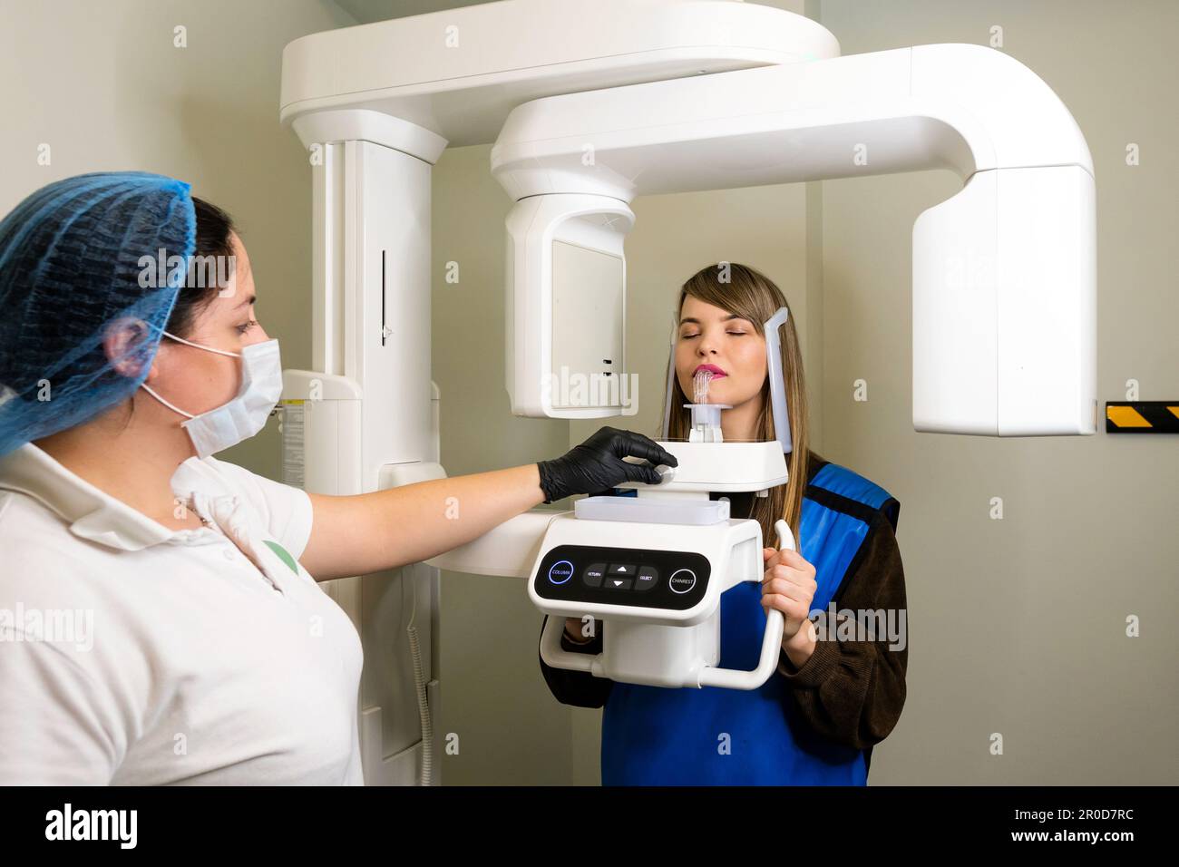 X-ray technician makes CT scan of jaw female patient. Woman making ...