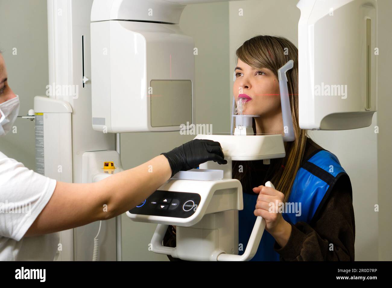 X-ray technician makes CT scan of jaw female patient. Woman making ...