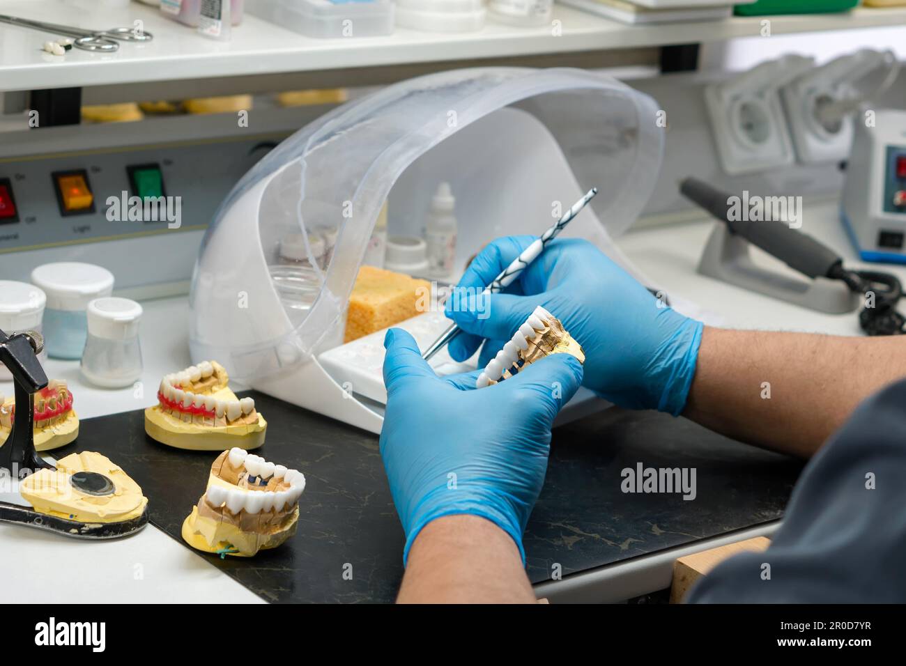 Dental prosthesis work. Denture work. Teeth painting. Dental technician ...