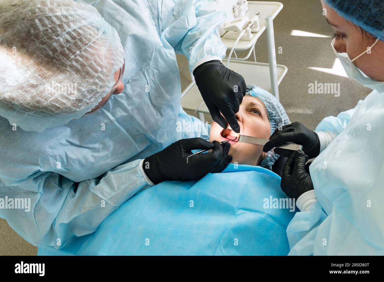 Surgeon and nurse during dental operation. Local anesthetized female ...
