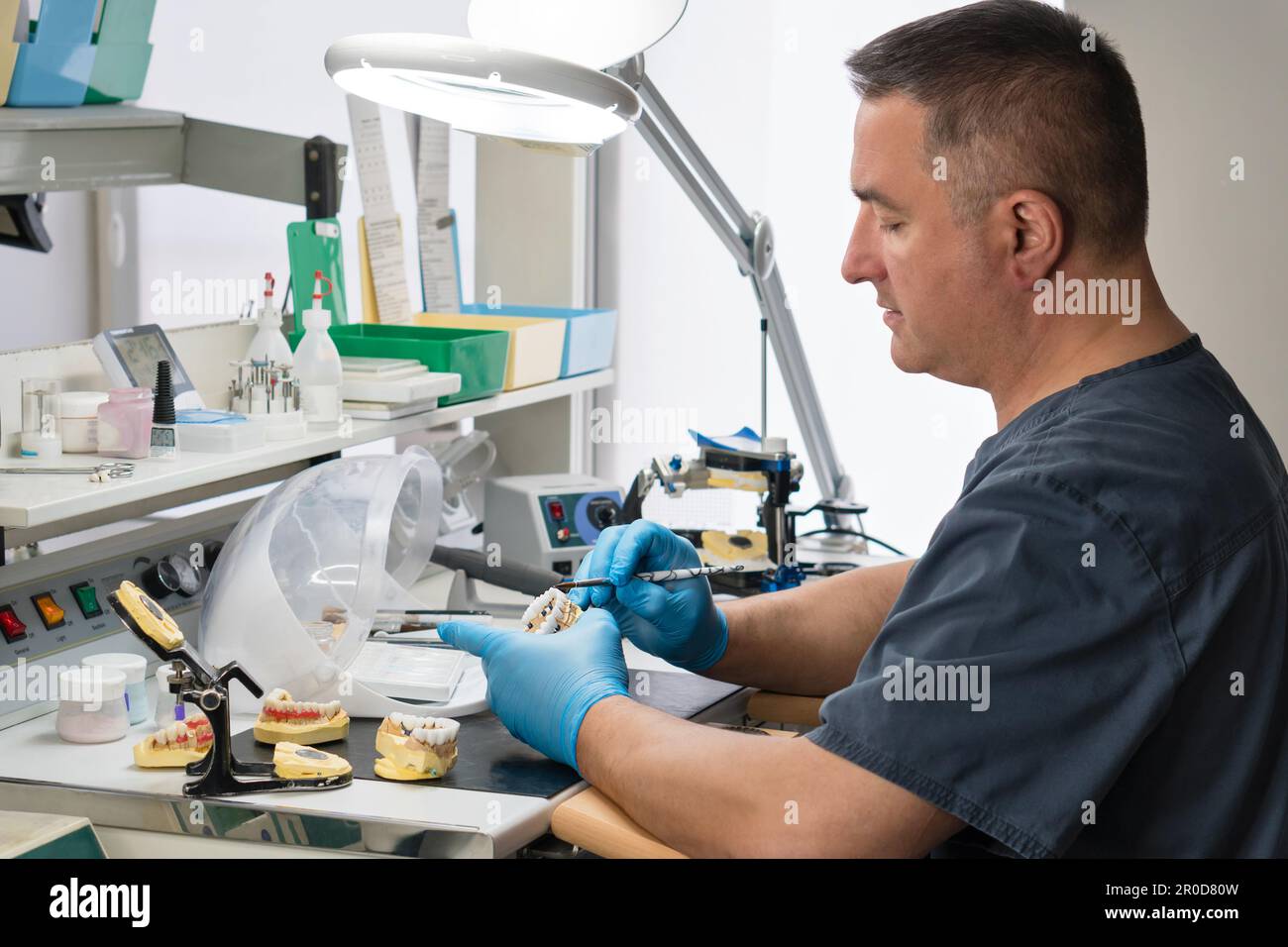 Dental prosthesis work. Denture work. Teeth painting. Dental technician ...