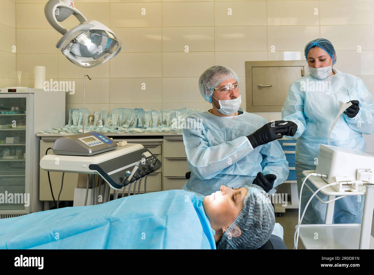 Surgeon and nurse during dental operation. Local anesthetized female ...