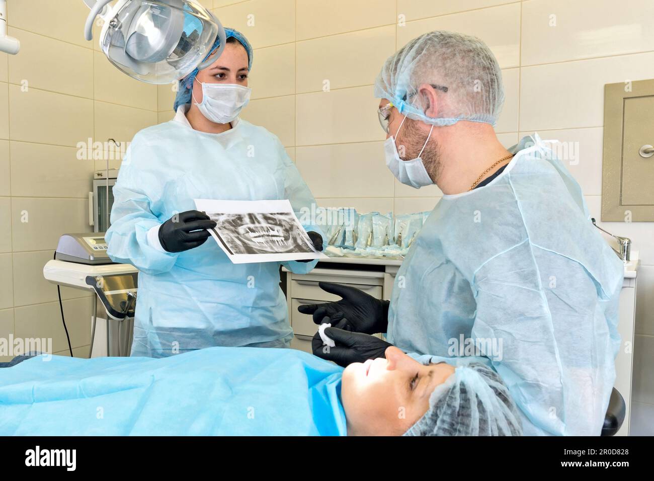 Nurse Shows X Ray To Surgeon Before Removing Molar Tooth From Female