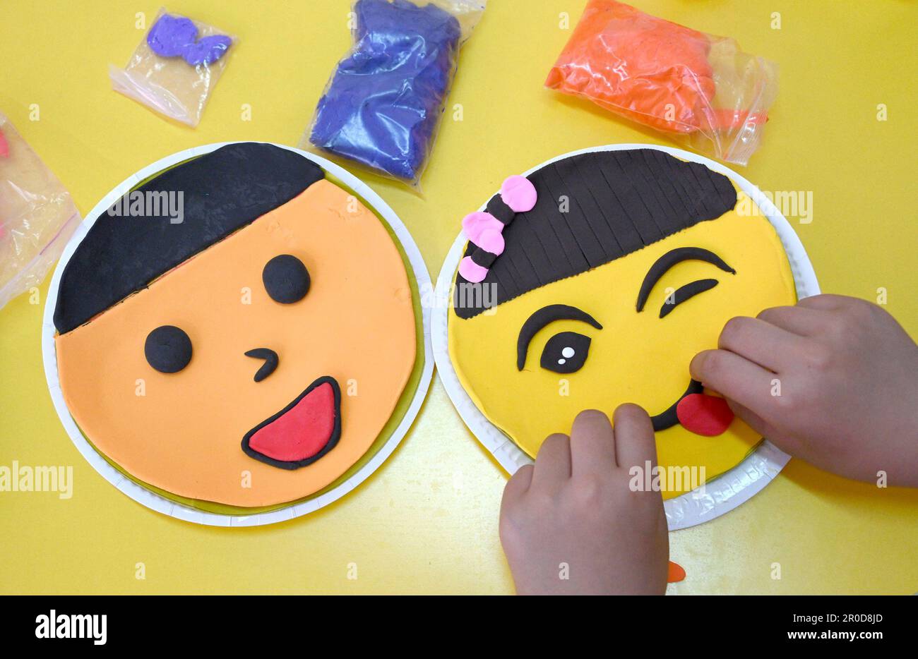 A child makes handicrafts of smiley faces at a primary school in Handan ...