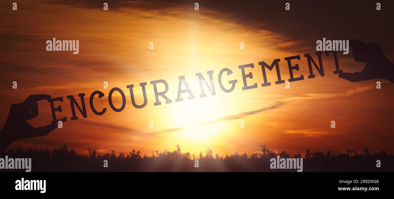 Encouragement - human hands holding black silhouette word Stock Photo ...