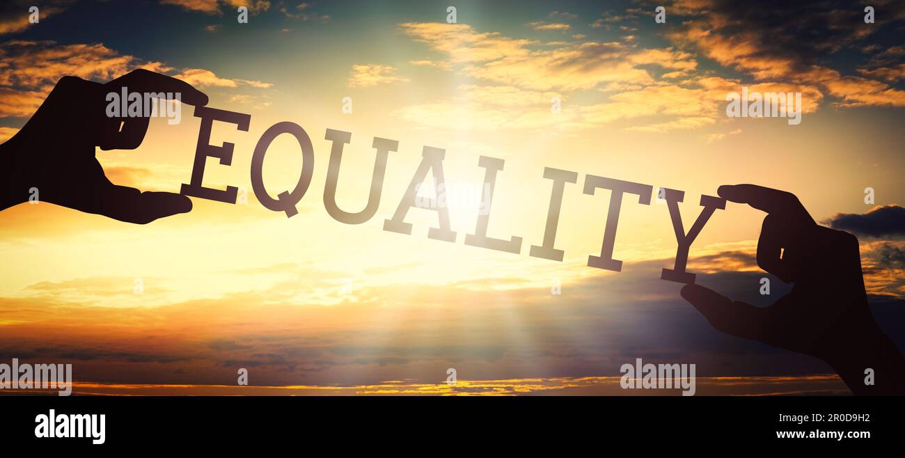 Equality - human hands holding black silhouette word Stock Photo - Alamy