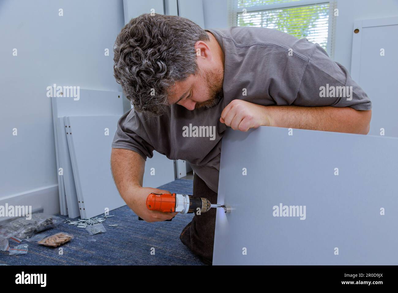 An assembly installation of closet cabinet for furniture is being ...