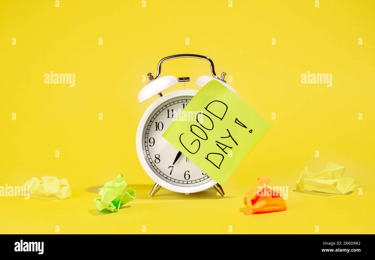 Alarm clock and paper reminder with inscription Good day, isolated ...