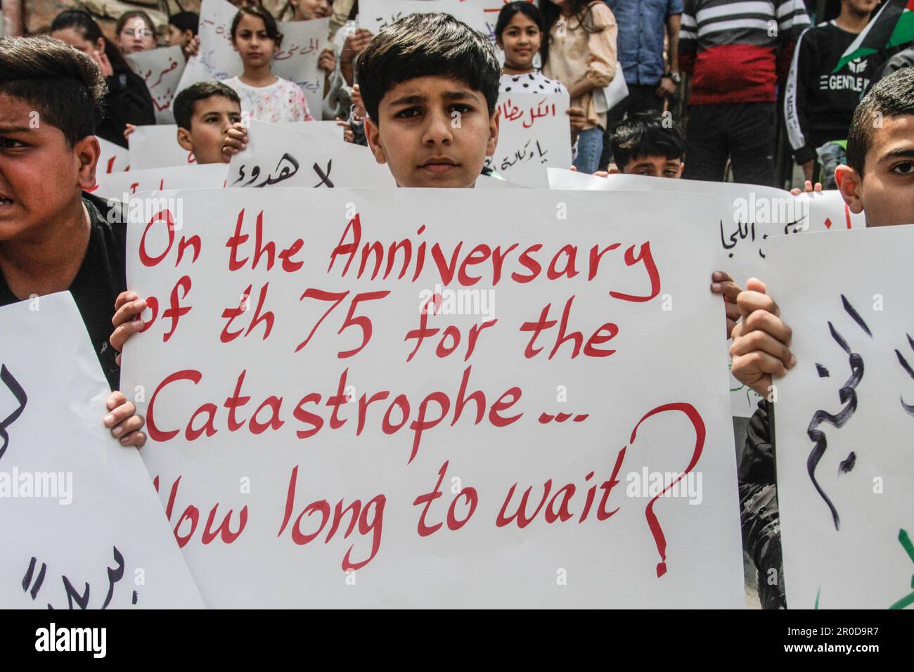 Nablus, Palestine. 08th May, 2023. A Palestinian kid holds a placard in ...