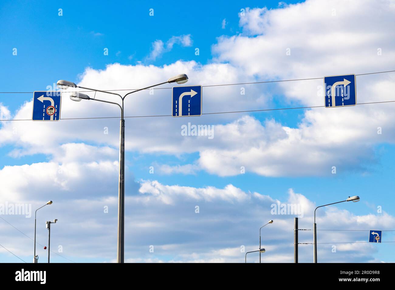 hanging road sign with an arrow indicating the direction of travel ...